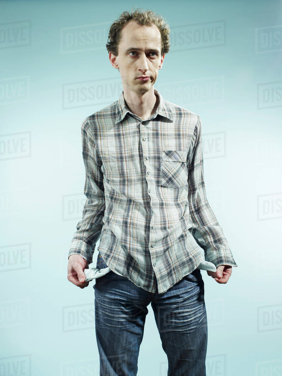 A man turns his pockets inside out to symbolize having no money - Stock ...