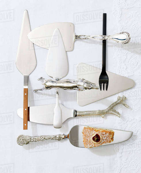 Various cake servers and a slice of cake - Royalty-free Stock Photo ...
