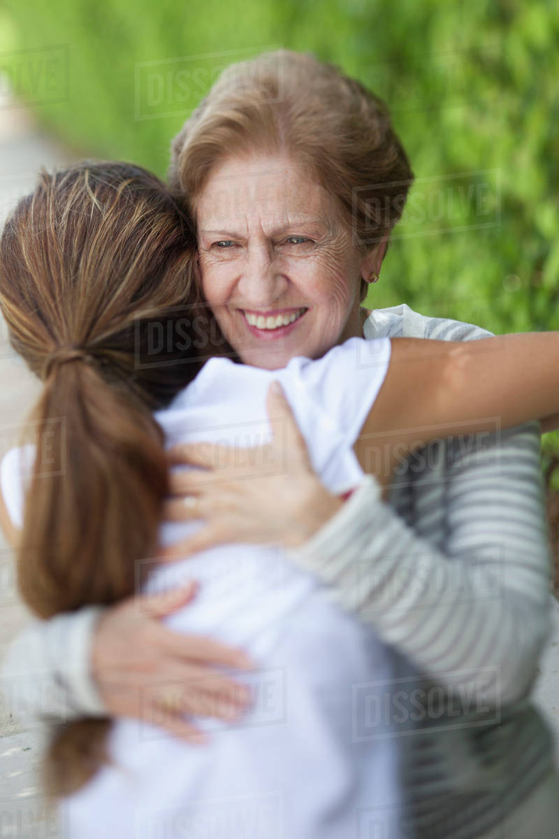 A senior woman hugging a young woman - Royalty-free Stock Photo | Dissolve