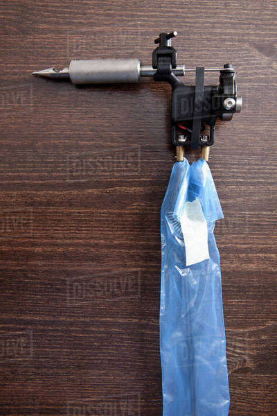 A tattoo gun on a table, close-up - Stock Photo - Dissolve