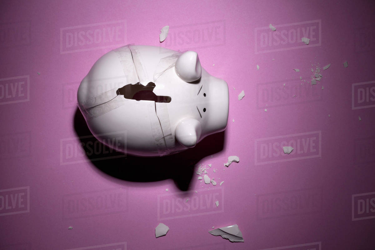 A broken piggy bank with pieces taped back together - Stock Photo ...