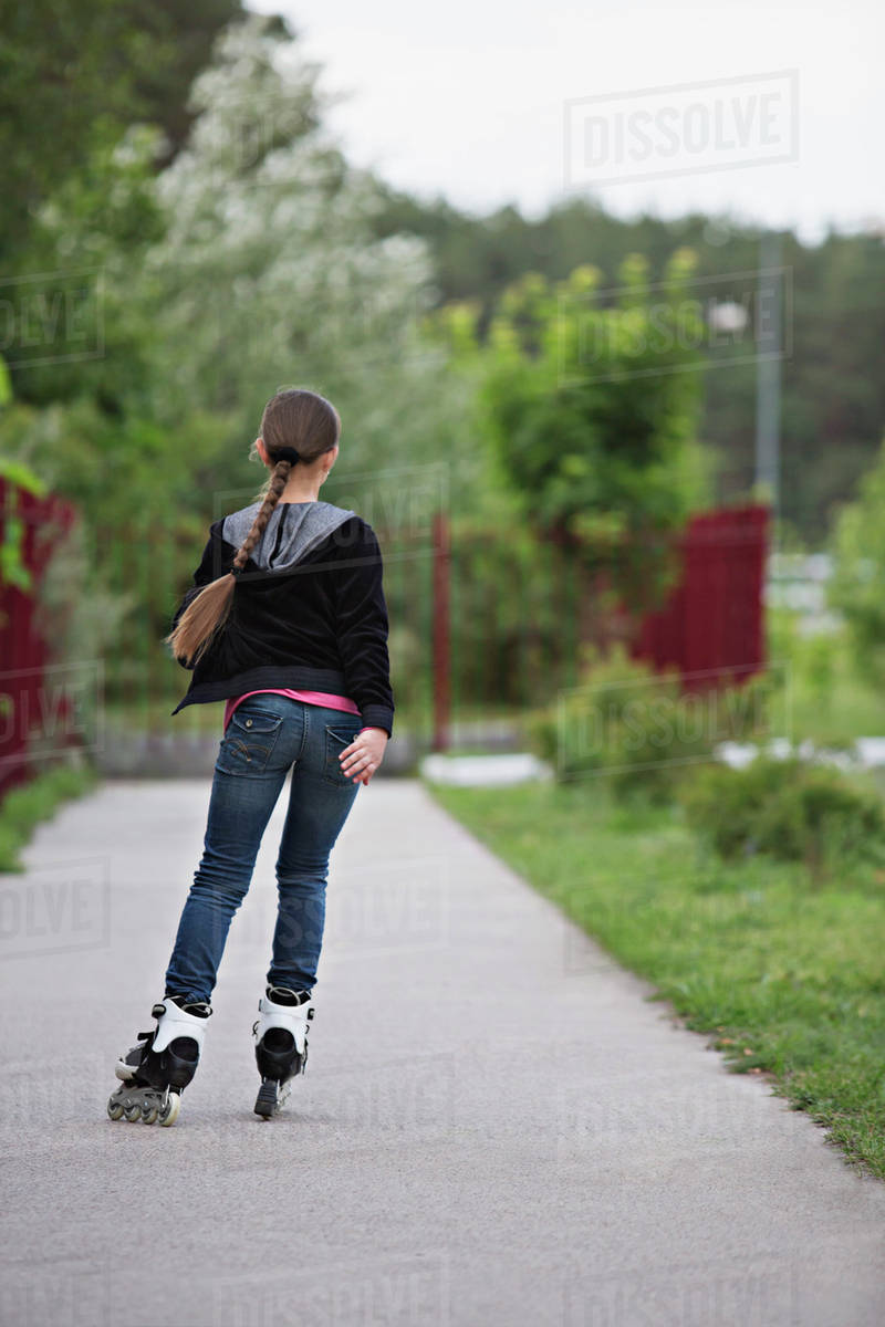 Rear view of a girl inline skating - Royalty-free Stock Photo | Dissolve