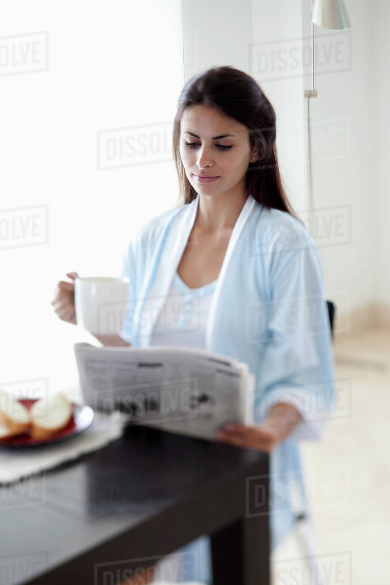 Woman reading the morning newspaper - Royalty-free Stock Photo | Dissolve