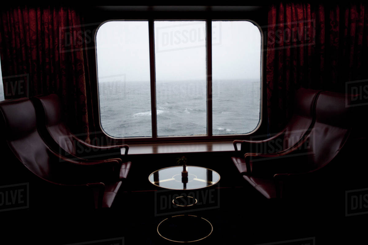 View of Pacific Ocean through the window of lounge area on a passenger ...