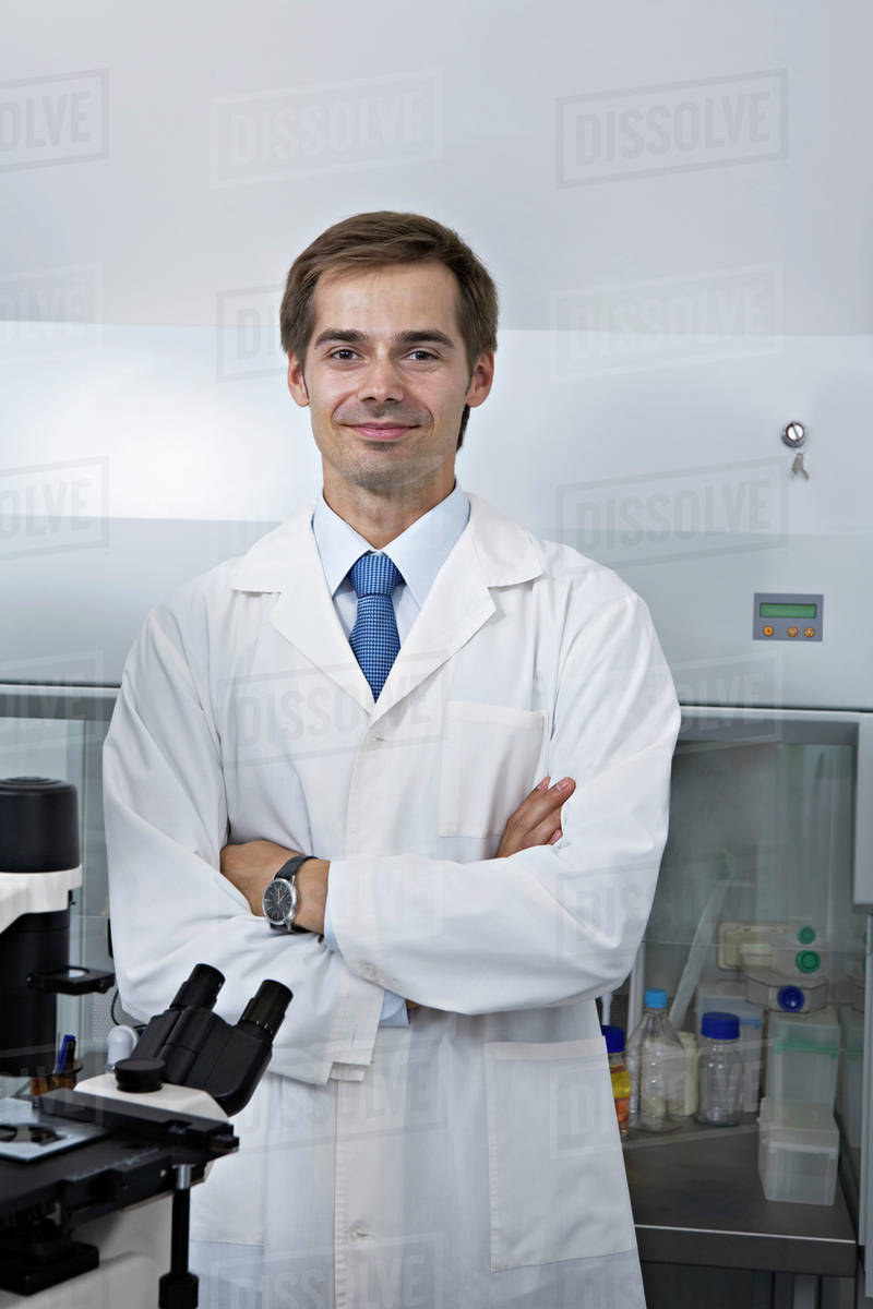 A smiling research technician standing in a research lab - Royalty-free ...