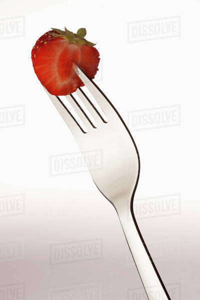 Half a strawberry on a fork - Royalty-free Stock Photo | Dissolve