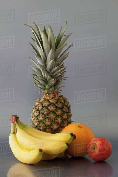 Pineapple, bananas, orange and apple - Royalty-free Stock Photo | Dissolve