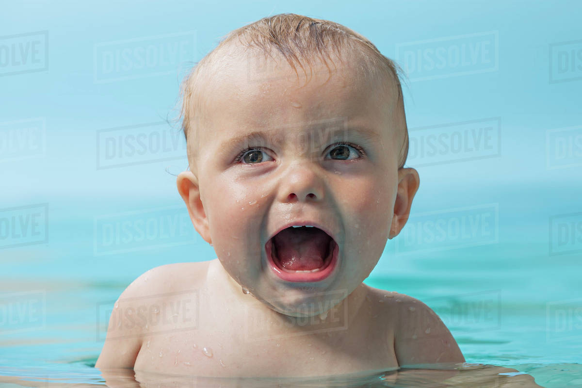Unhappy baby in water - Royalty-free Stock Photo | Dissolve