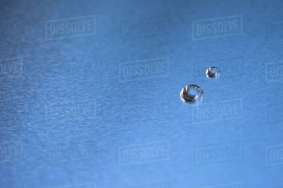 Two water drops on a blue background - Stock Photo - Dissolve