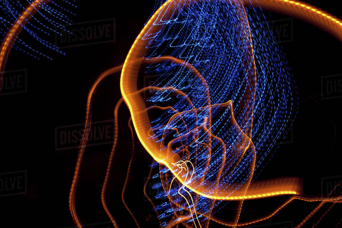Abstract patterns of blue and orange light trails - Stock Photo - Dissolve