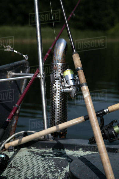 An arrangement of various fishing rods on a lake jetty - Royalty-free ...