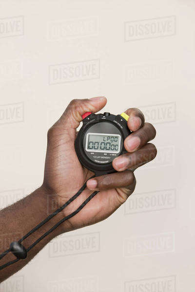 Man holding digital stopwatch - Royalty-free Stock Photo | Dissolve