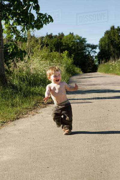 Baby girl running on single track - Stock Photo - Dissolve
