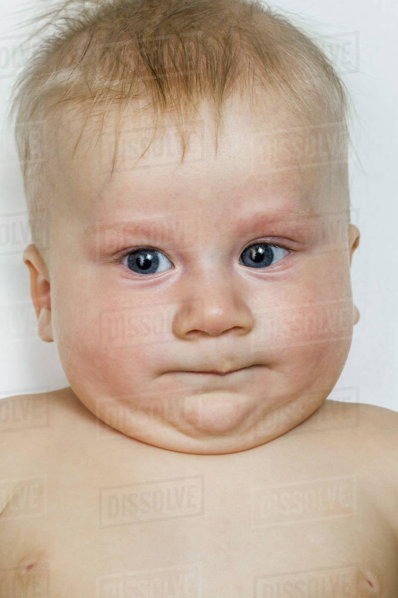 A baby boy grimacing, close-up - Stock Photo - Dissolve
