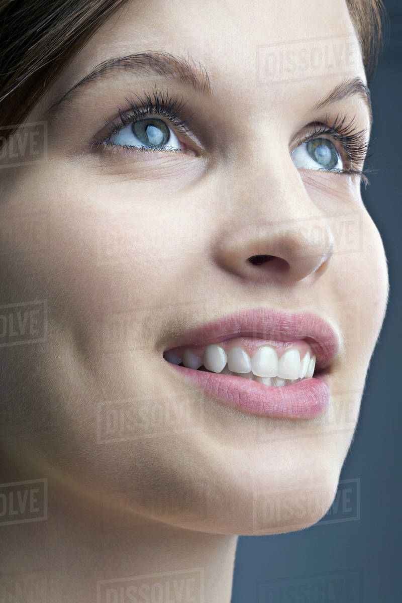 Young woman looking up and smiling, close-up - Royalty-free Stock Photo ...
