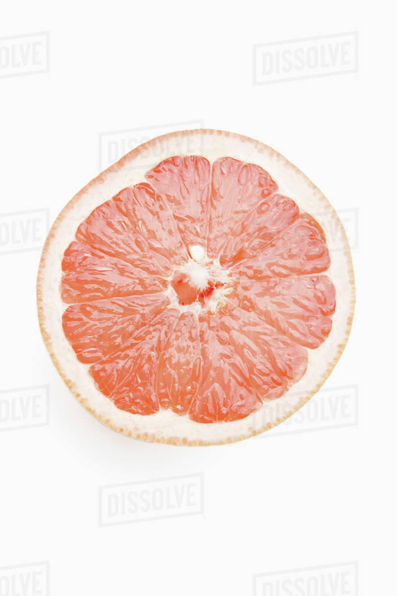 Cross section of grapefruit against white background - Royalty-free ...