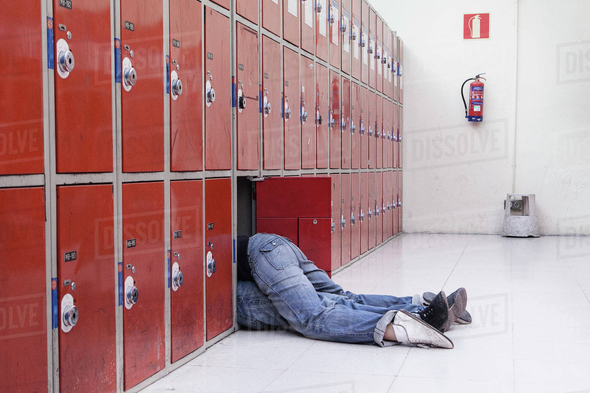 Low section of couple making love inside locker - Stock Photo - Dissolve