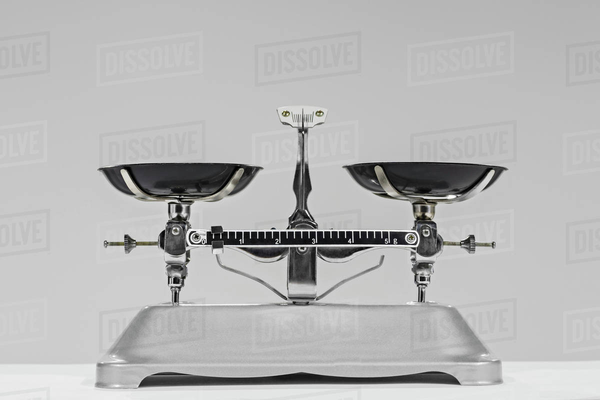 Old-fashioned weighing scale against gray background - Stock Photo ...