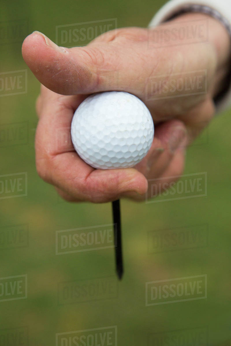 Cropped image of hand holding golf ball outdoors - Royalty-free Stock ...