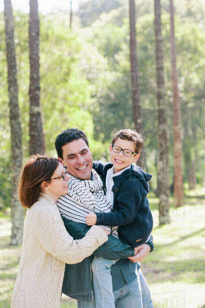 Happy family in forest - Stock Photo - Dissolve