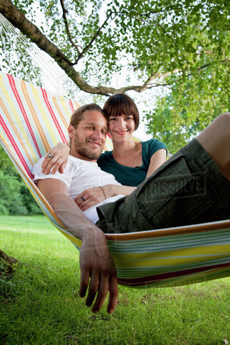 A young happy couple lying in a hammock together - Royalty-free Stock ...
