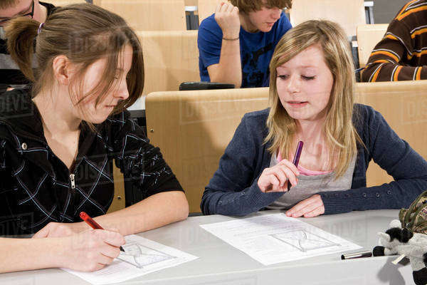 Two students working on worksheets together - Royalty-free Stock Photo ...