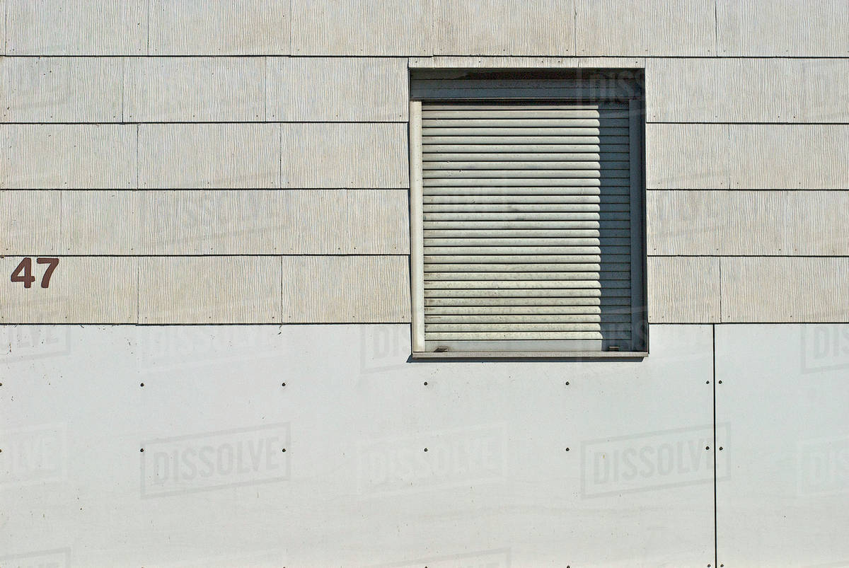 A closed rolling window shutter - Stock Photo - Dissolve