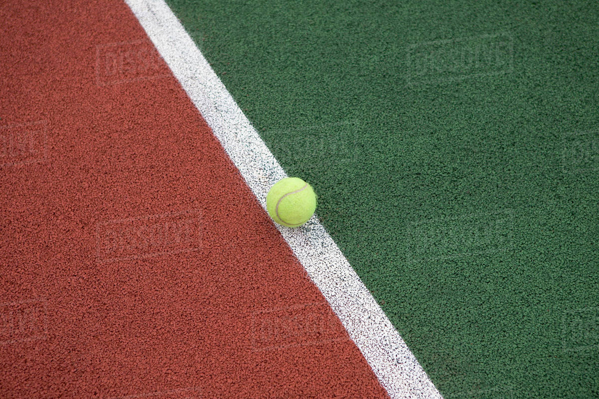 Tennis ball on the line close-up - Stock Photo - Dissolve