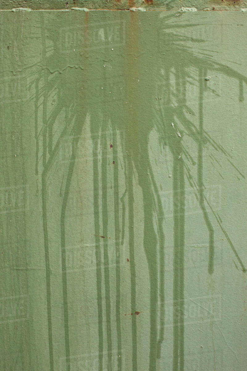 A liquid stain on a green wall - Stock Photo - Dissolve