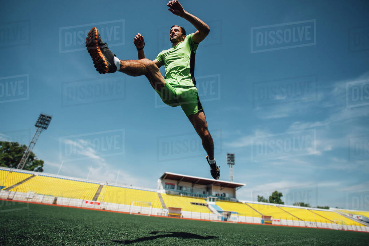 Full length of young athlete running in stadium during training - Stock ...
