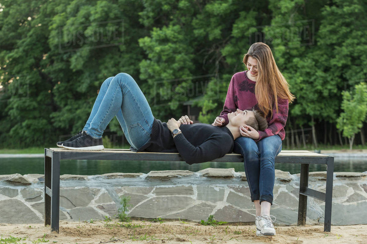 Full length of man lying on girlfriend's lap at park - Royalty-free ...