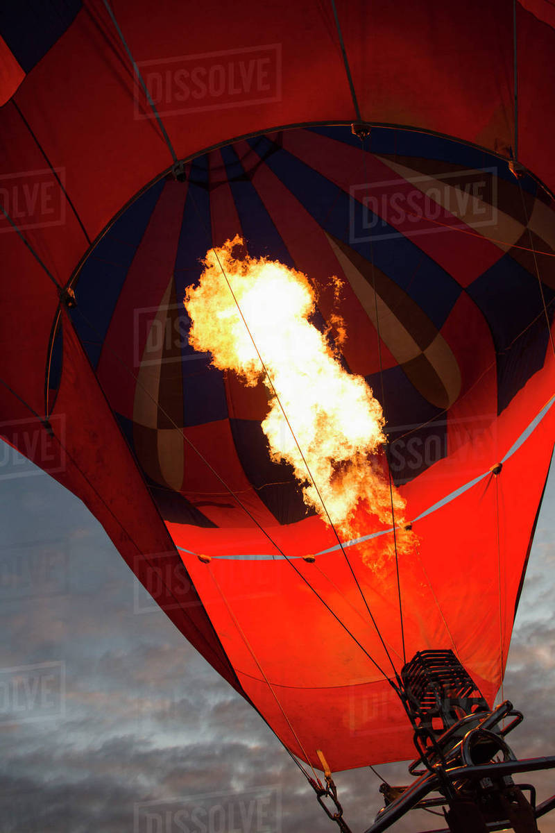 Low angle view of fire in hot air balloon against sky - Royalty-free ...