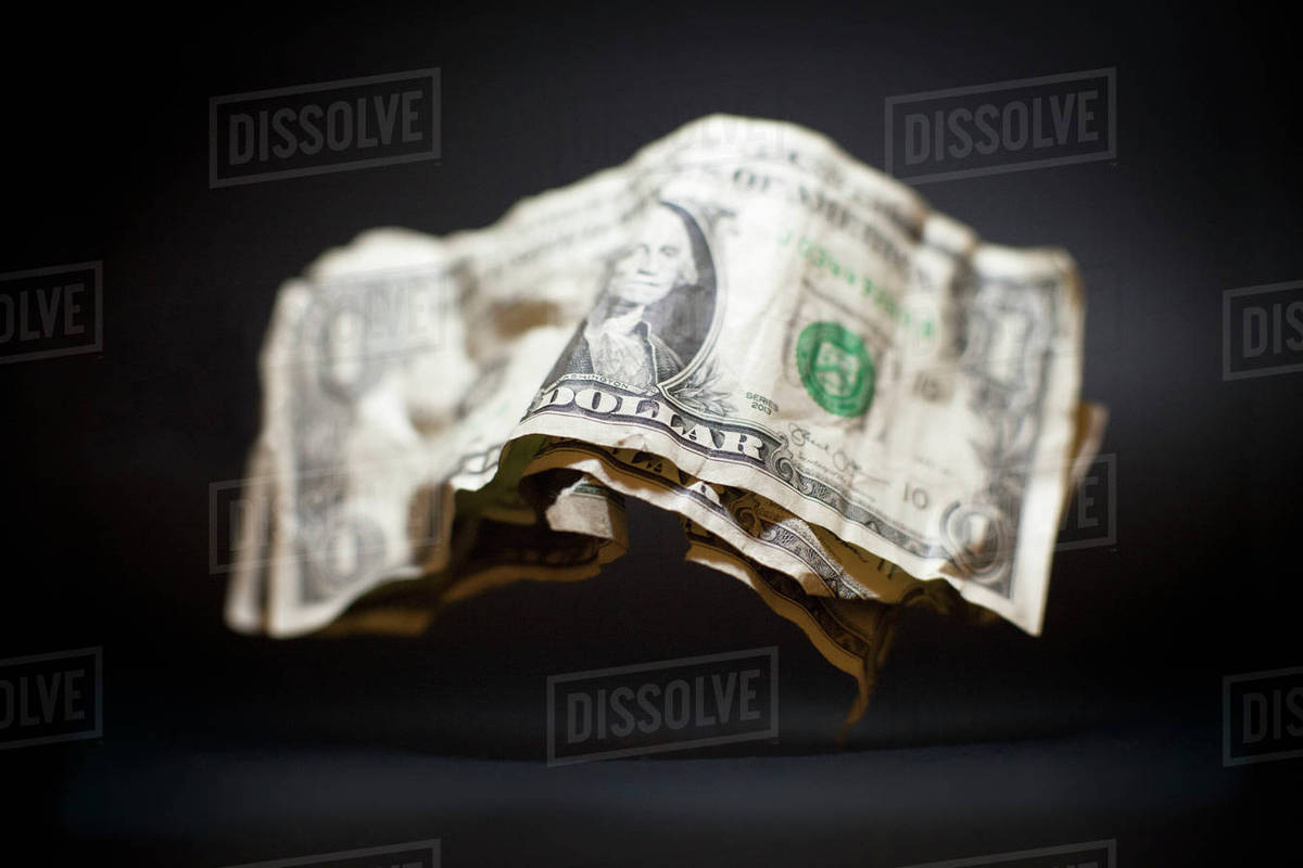 Close-up of crumpled old American one dollar bills levitating against ...