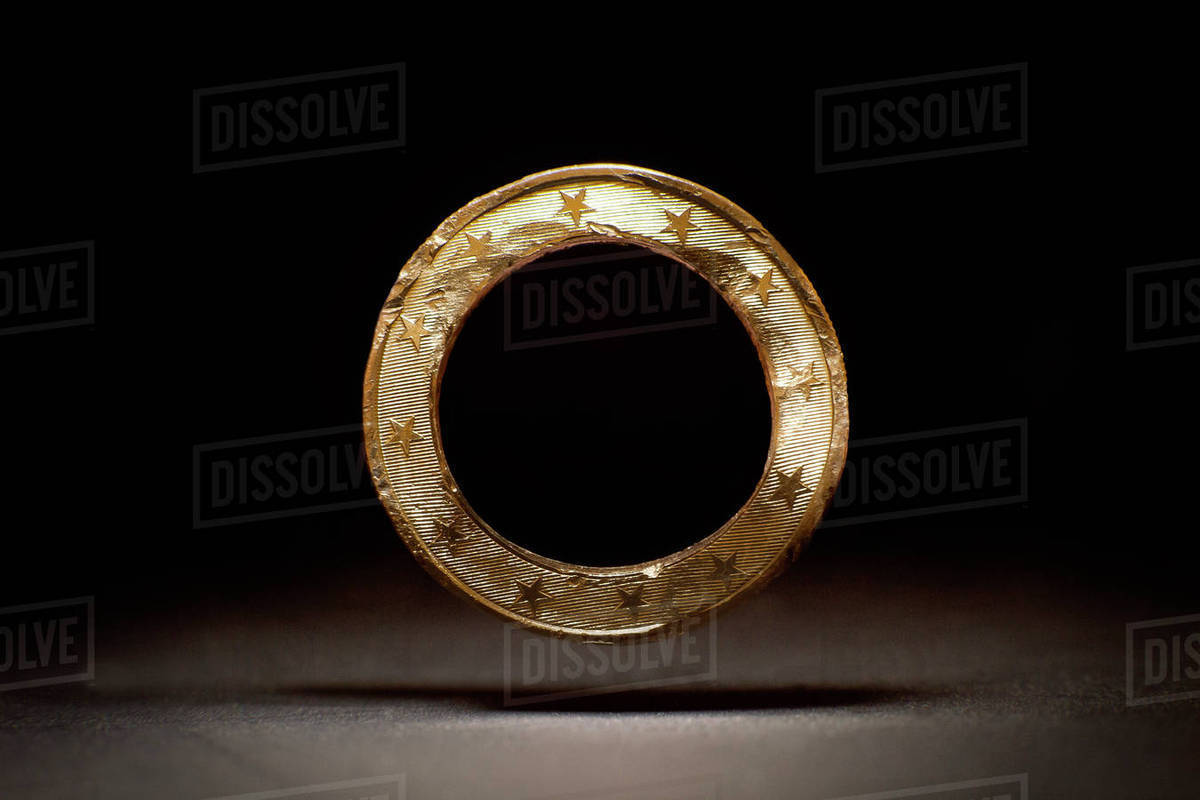 Damaged metal of Euro coin levitating against black background - Stock ...