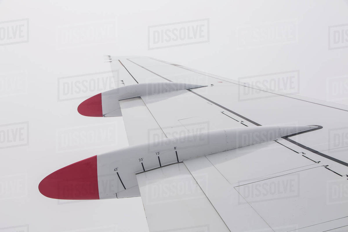 Cropped image of aircraft wing flying against sky - Royalty-free Stock ...