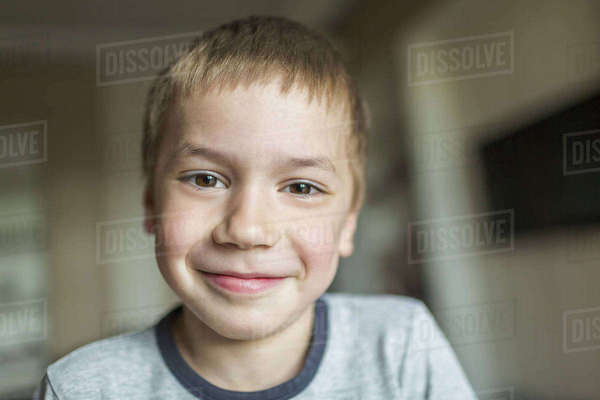 Portrait of smiling boy at home - Stock Photo - Dissolve