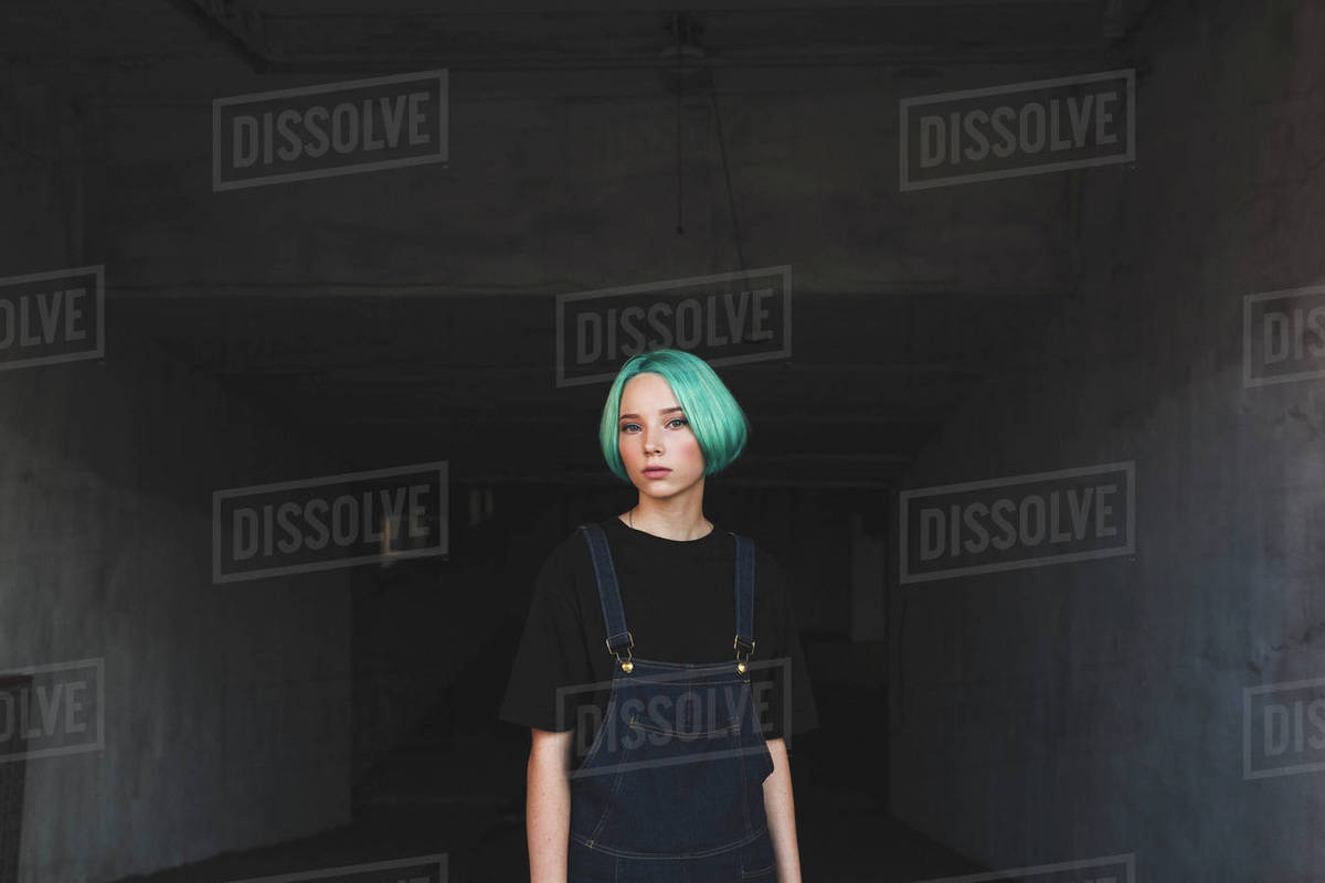 Portrait of teenage girl standing in basement - Royalty-free Stock ...