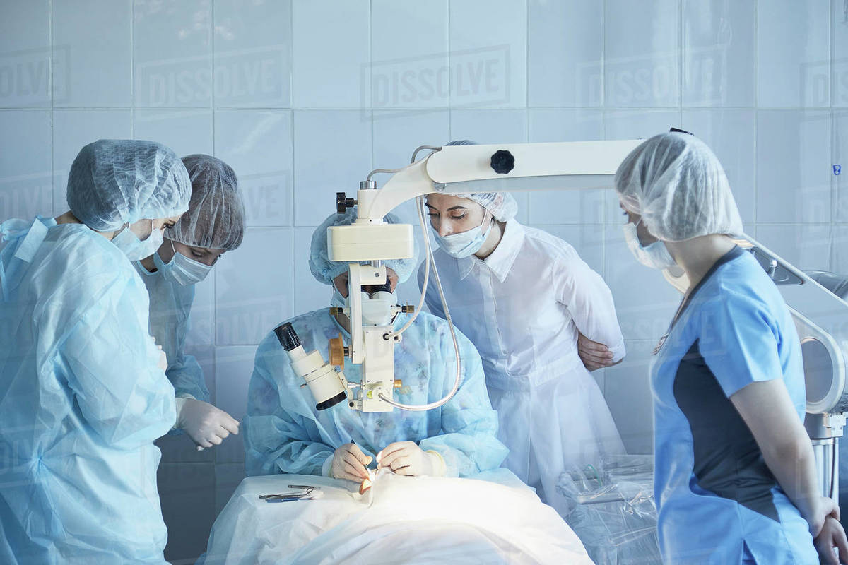 Medical team performing surgery on patient at hospital - Royalty-free ...