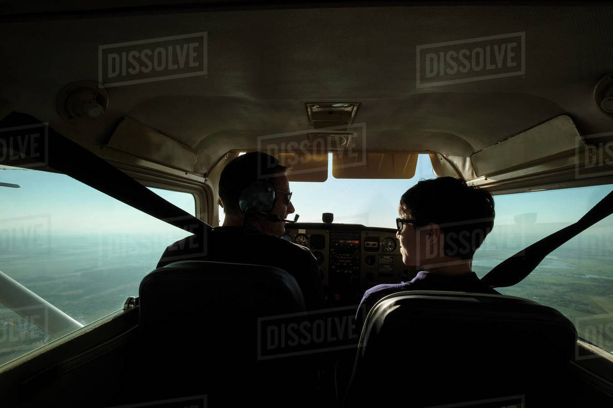 Father and son flying in small airplane - Royalty-free Stock Photo ...