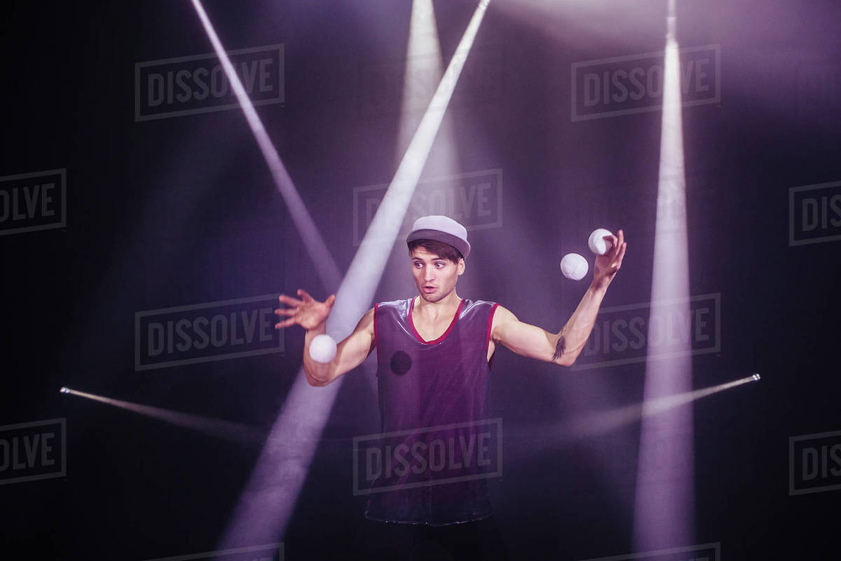 Male performer juggling on stage - Stock Photo - Dissolve