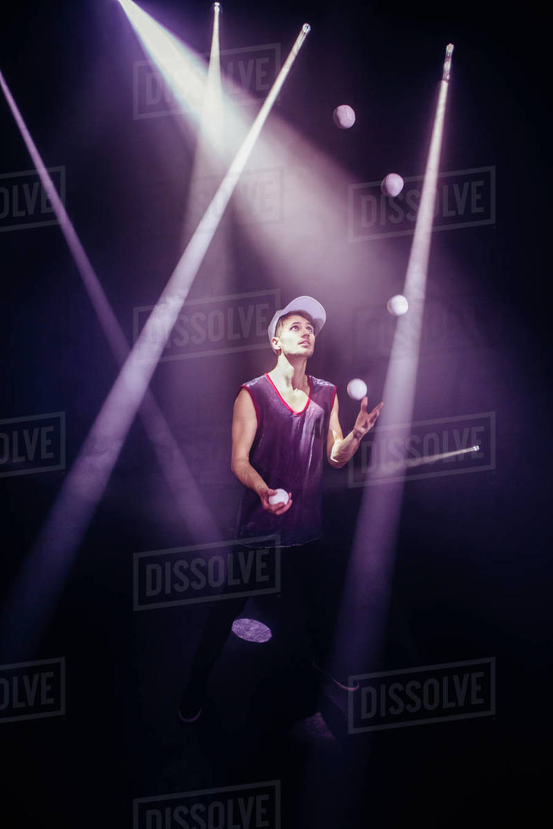 Male performer juggling on stage - Stock Photo - Dissolve
