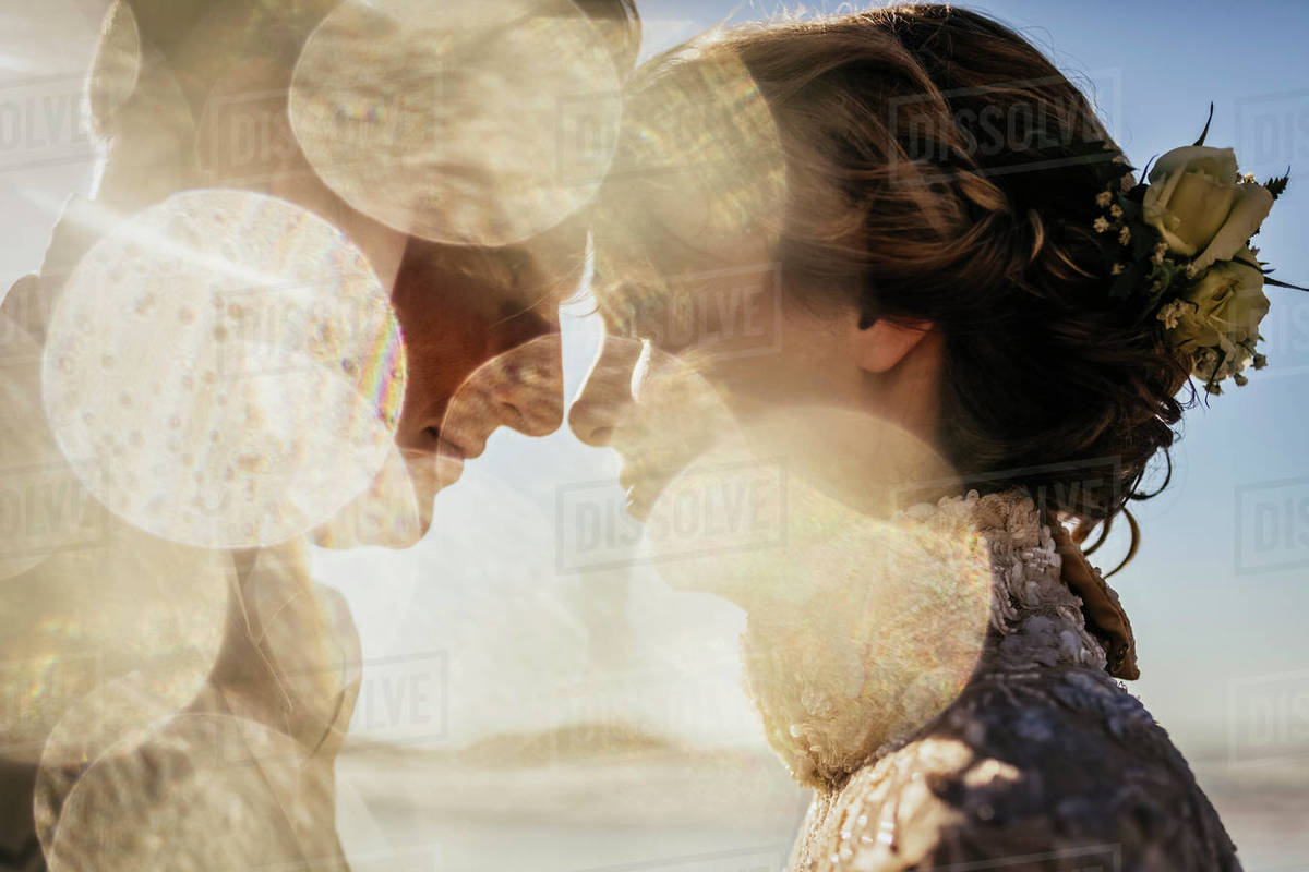 Golden light illuminating profile of bride and groom - Royalty-free ...