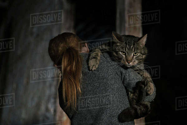 Girl holding cat over shoulder - Royalty-free Stock Photo | Dissolve