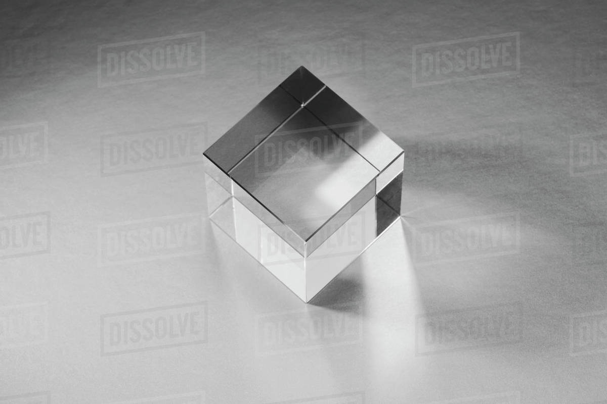 Clear, artificial resin cube reflecting light - Stock Photo - Dissolve