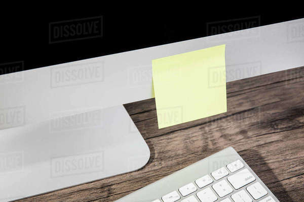 Blank adhesive note on computer - Stock Photo - Dissolve
