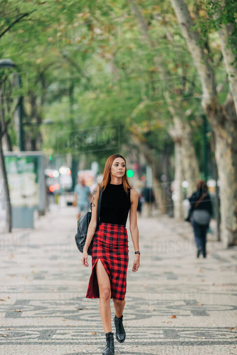 Stylish young woman walking in urban park - Royalty-free Stock Photo ...