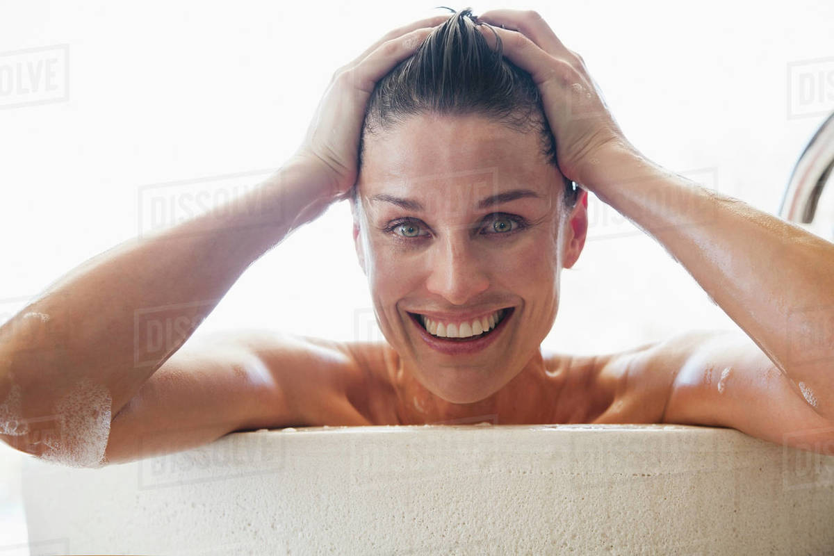 Portrait happy woman enjoying bath - Royalty-free Stock Photo | Dissolve