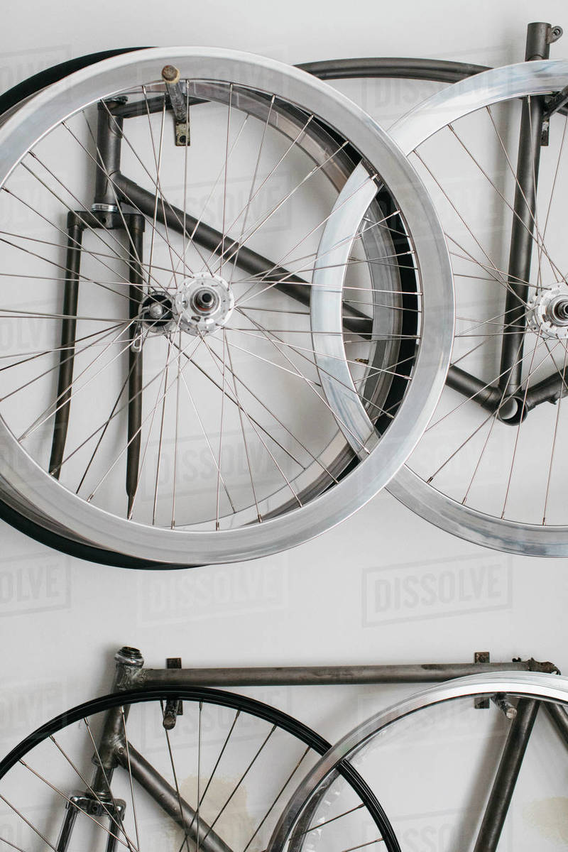 Bicycle rims and frames hanging on wall - Royalty-free Stock Photo ...