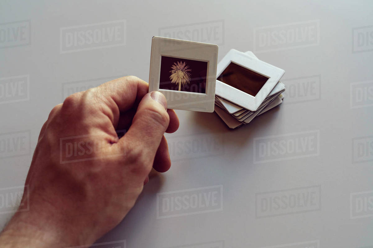 Hand holding photographic slides - Royalty-free Stock Photo | Dissolve