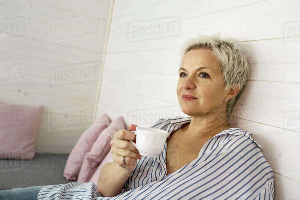 Serene woman enjoying tea - Royalty-free Stock Photo | Dissolve